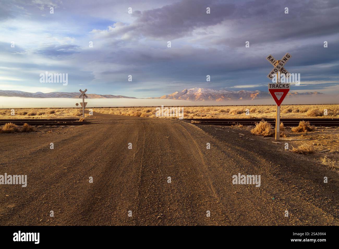 A remote railroad crossing in Flannigan, Nevada, glows in the golden ...