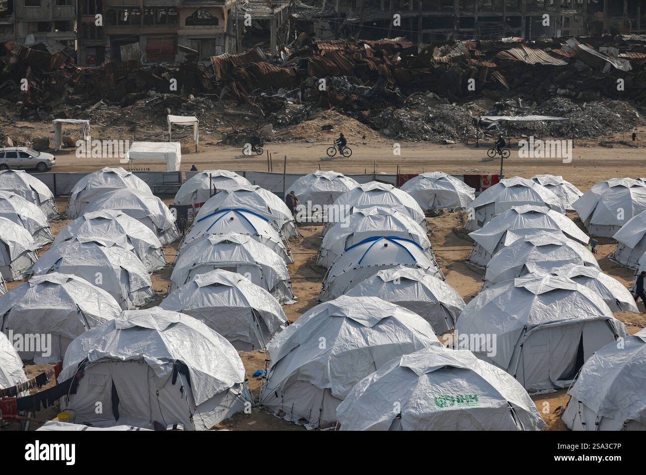 A tent camp for displaced Palestinians is set up amid destroyed ...