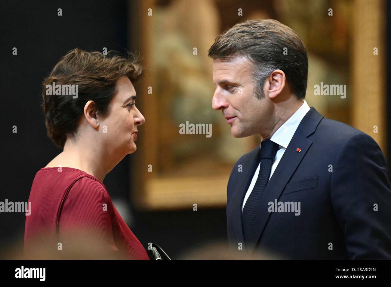 French President Emmanuel Macron speaks to the Louvre Museum director ...