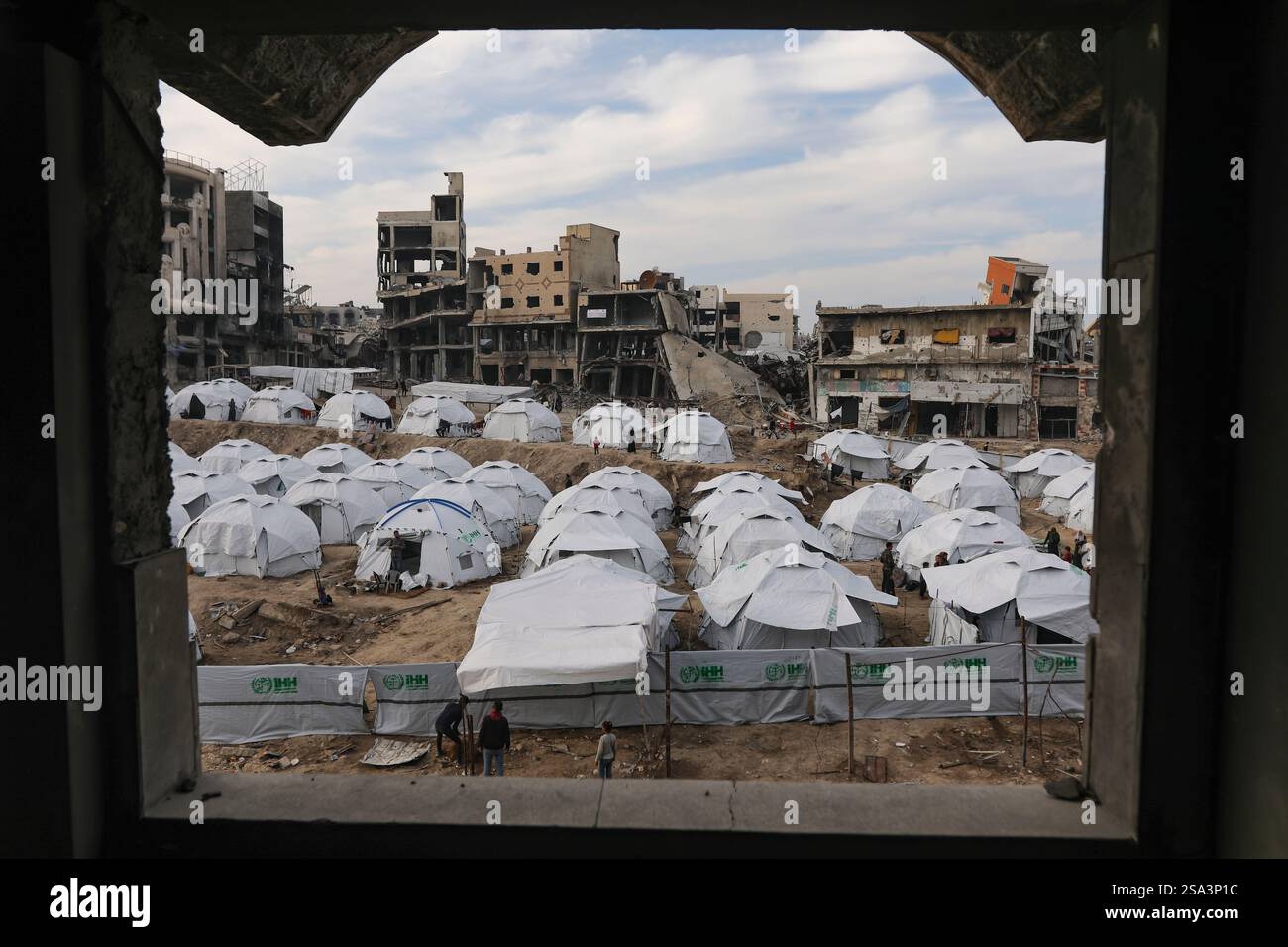 A tent camp for displaced Palestinians is set up amid destroyed ...