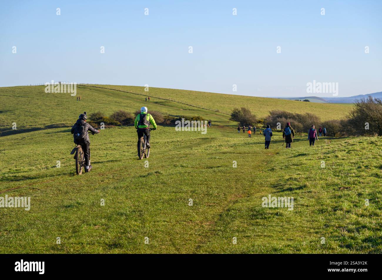 Cyclists and walkers, a sunny January day on the South Downs way in the ...