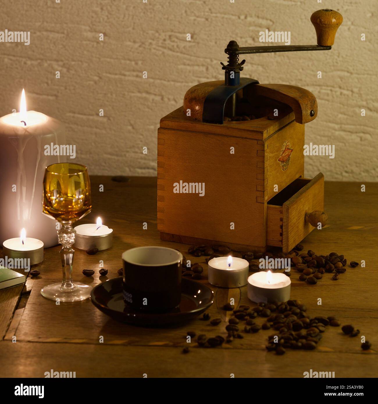 A vintage coffee grinder, candles, mocha cups Stock Photo - Alamy