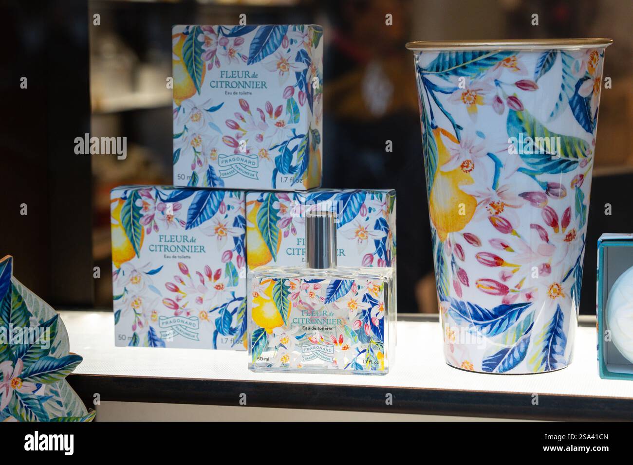 Brightly designed perfume bottles and packaging on display in a shop ...