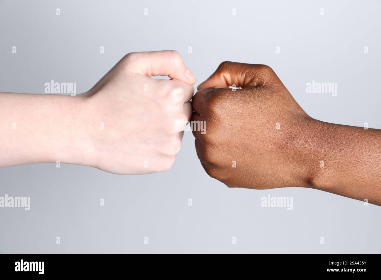 Stop racism. People of different skin colors bumping fists on light ...
