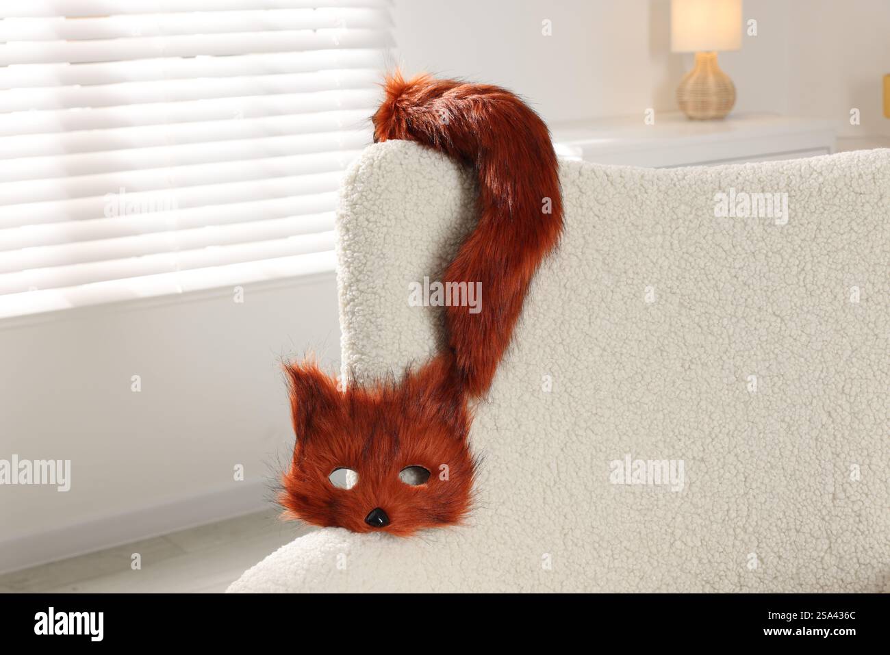 Quadrobics. Fox mask and tail on armchair indoors Stock Photo - Alamy