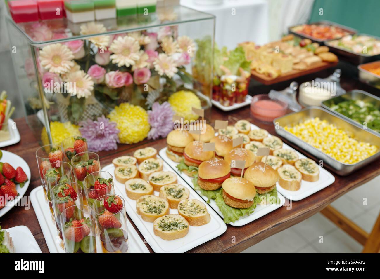 Setting up buffet table featuring various cuisines Stock Photo - Alamy