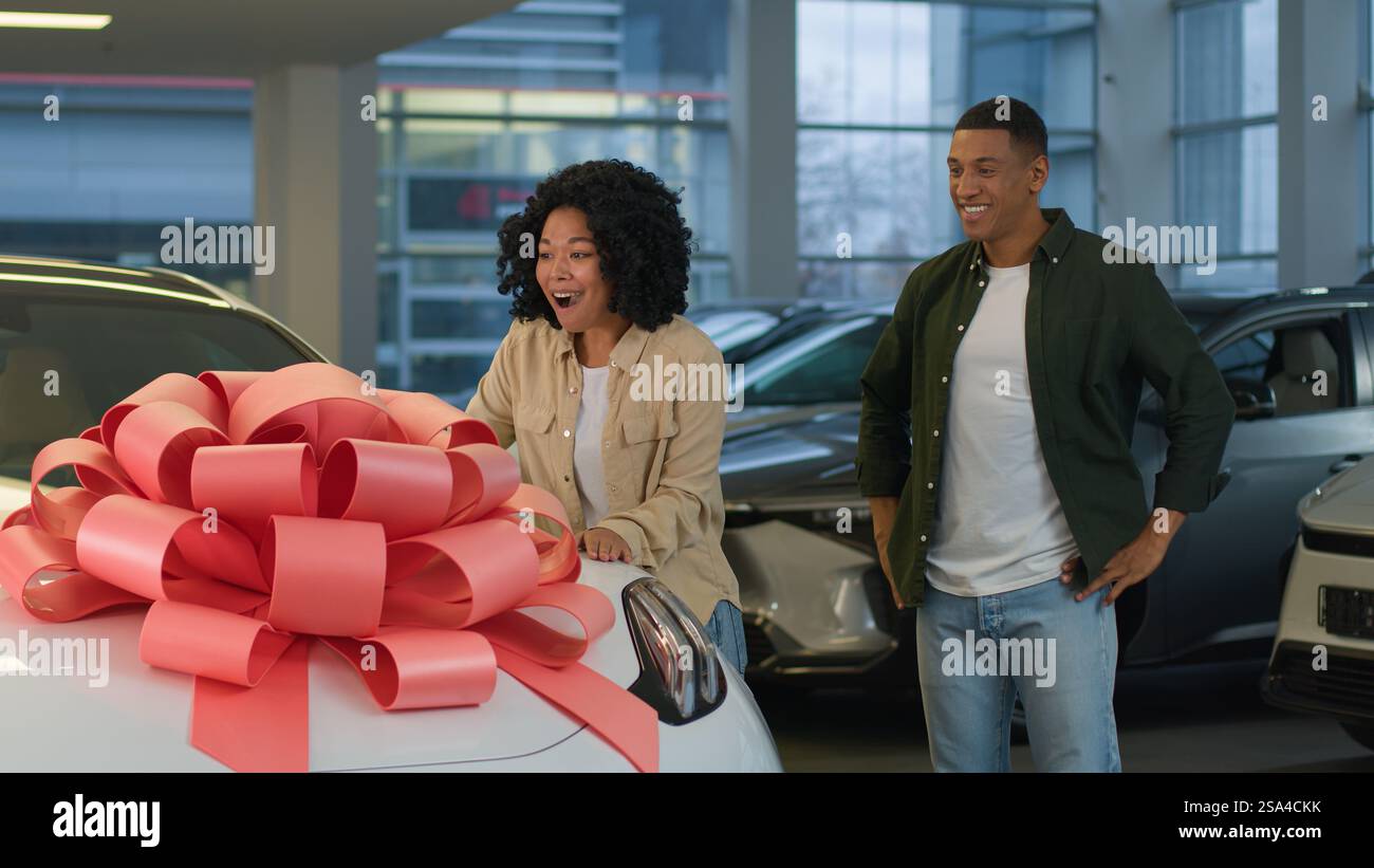 African American couple boyfriend girlfriend in dealership showroom ...