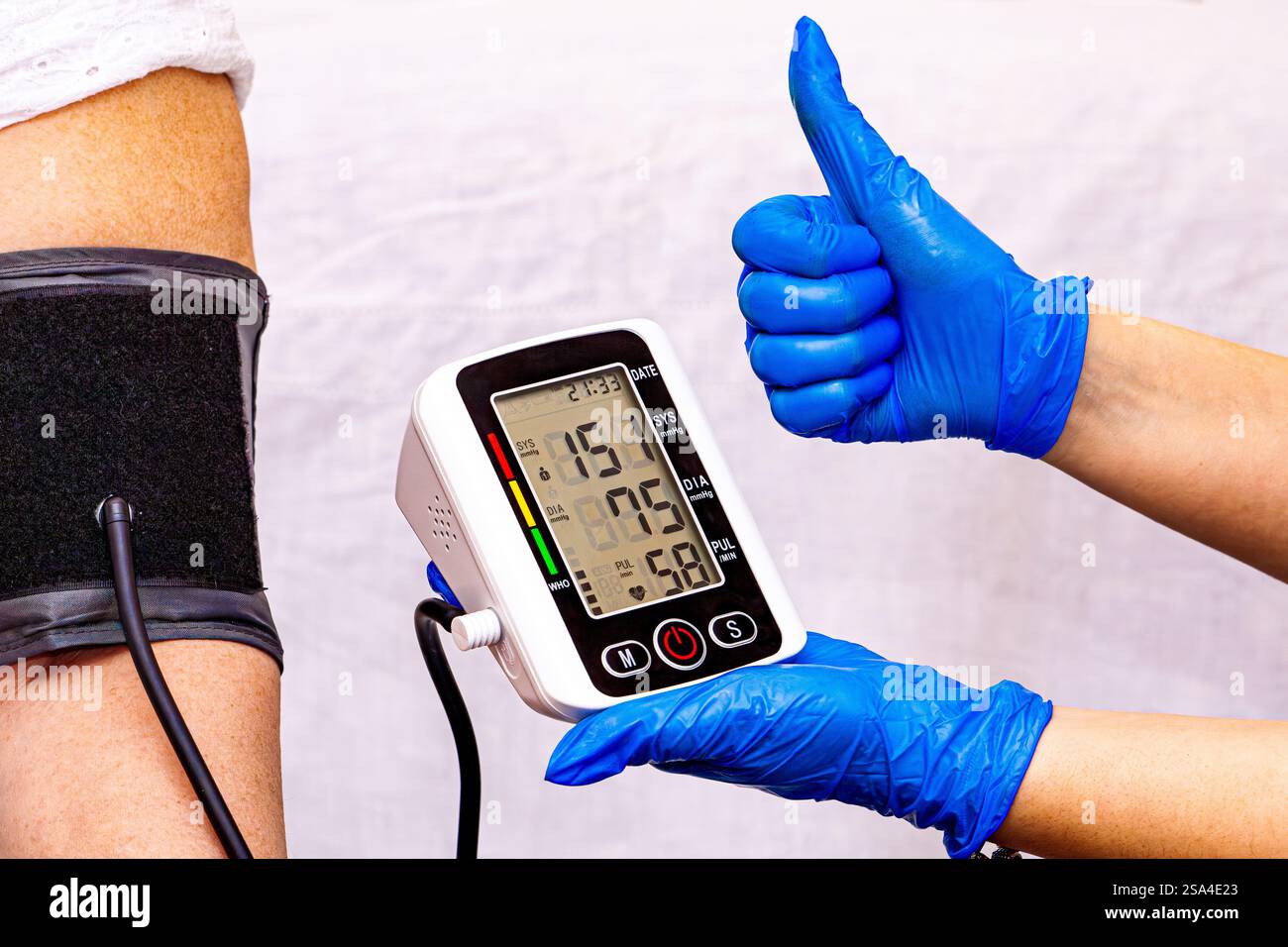 Nurse, elderly patient and blood pressure in house, retirement home and ...