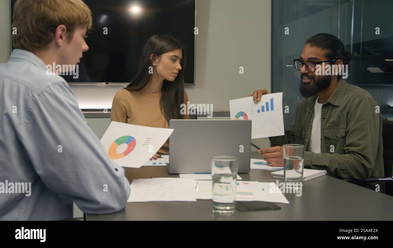 Team leader businessman coach showing corporate charts graphs on paper ...