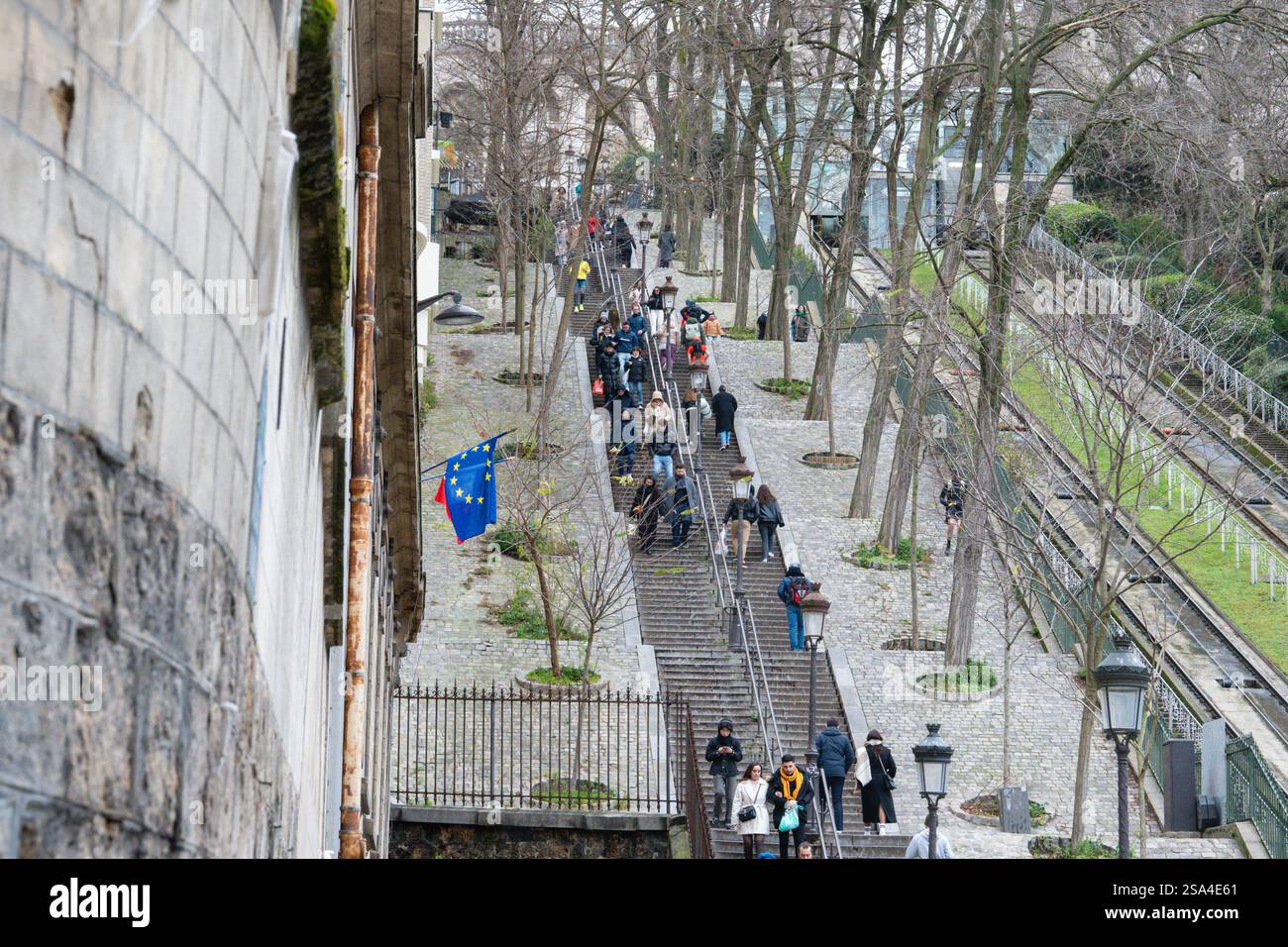 Stairs wind through a bustling park with people enjoying a bright day ...