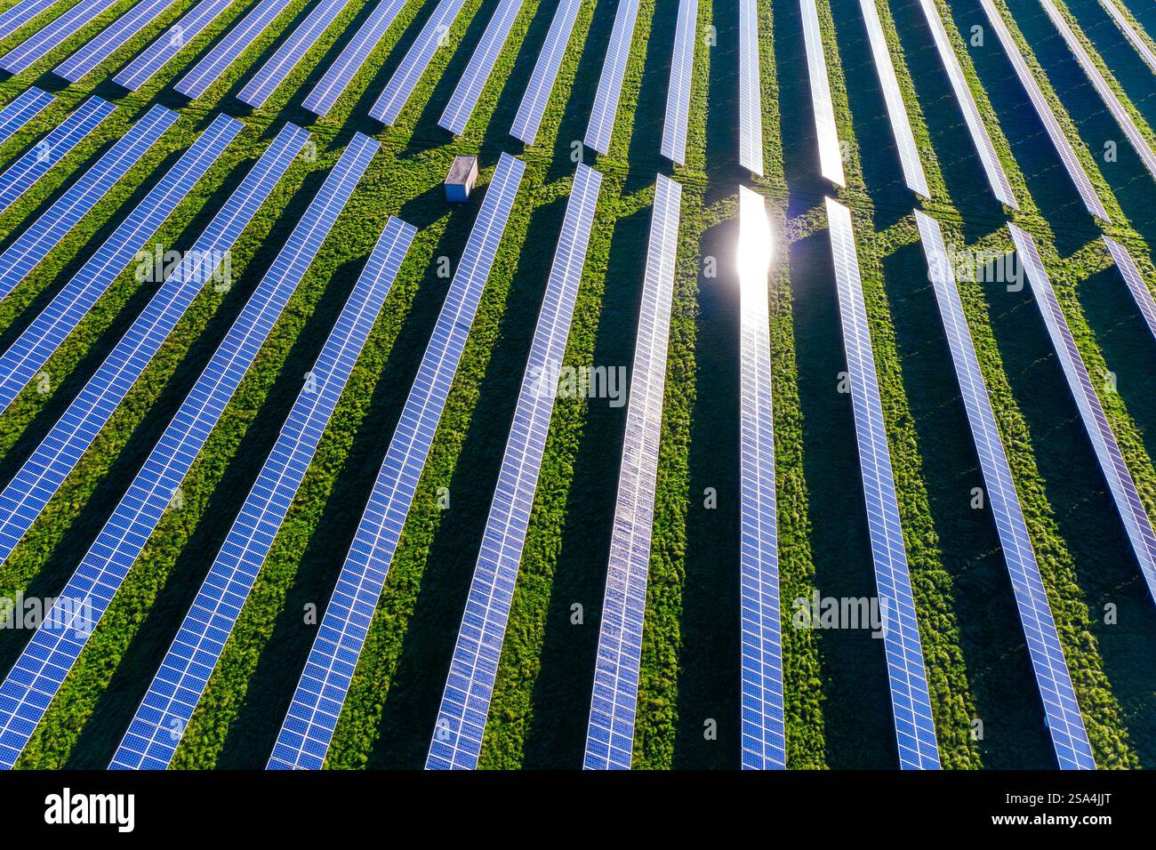 Aerial view over blue solar panels of photovoltaic power station ...