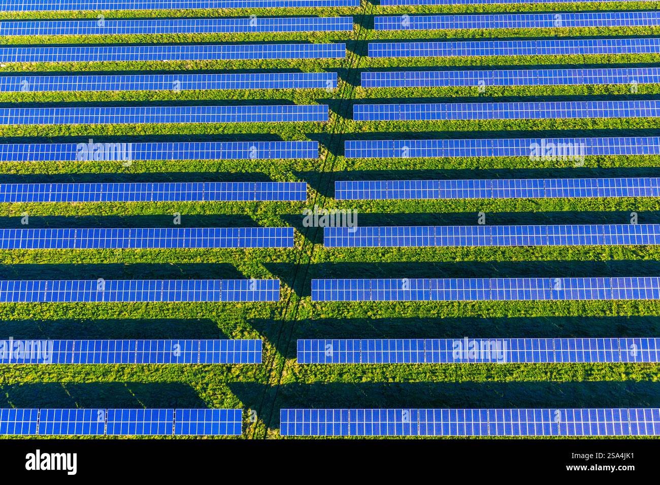 Aerial view over blue solar panels of photovoltaic power station ...