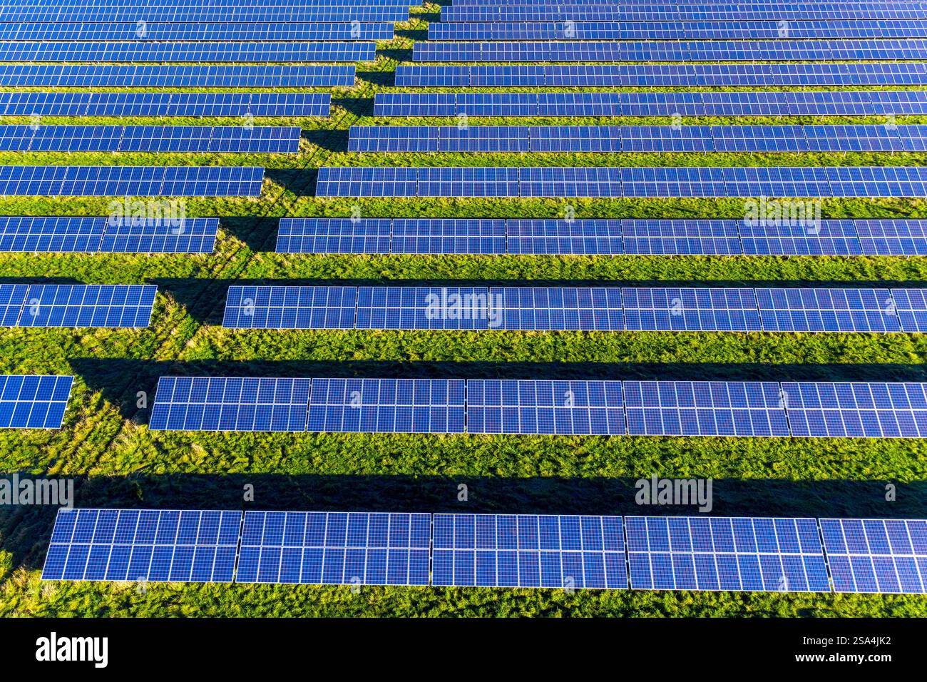 Aerial view over blue solar panels of photovoltaic power station ...