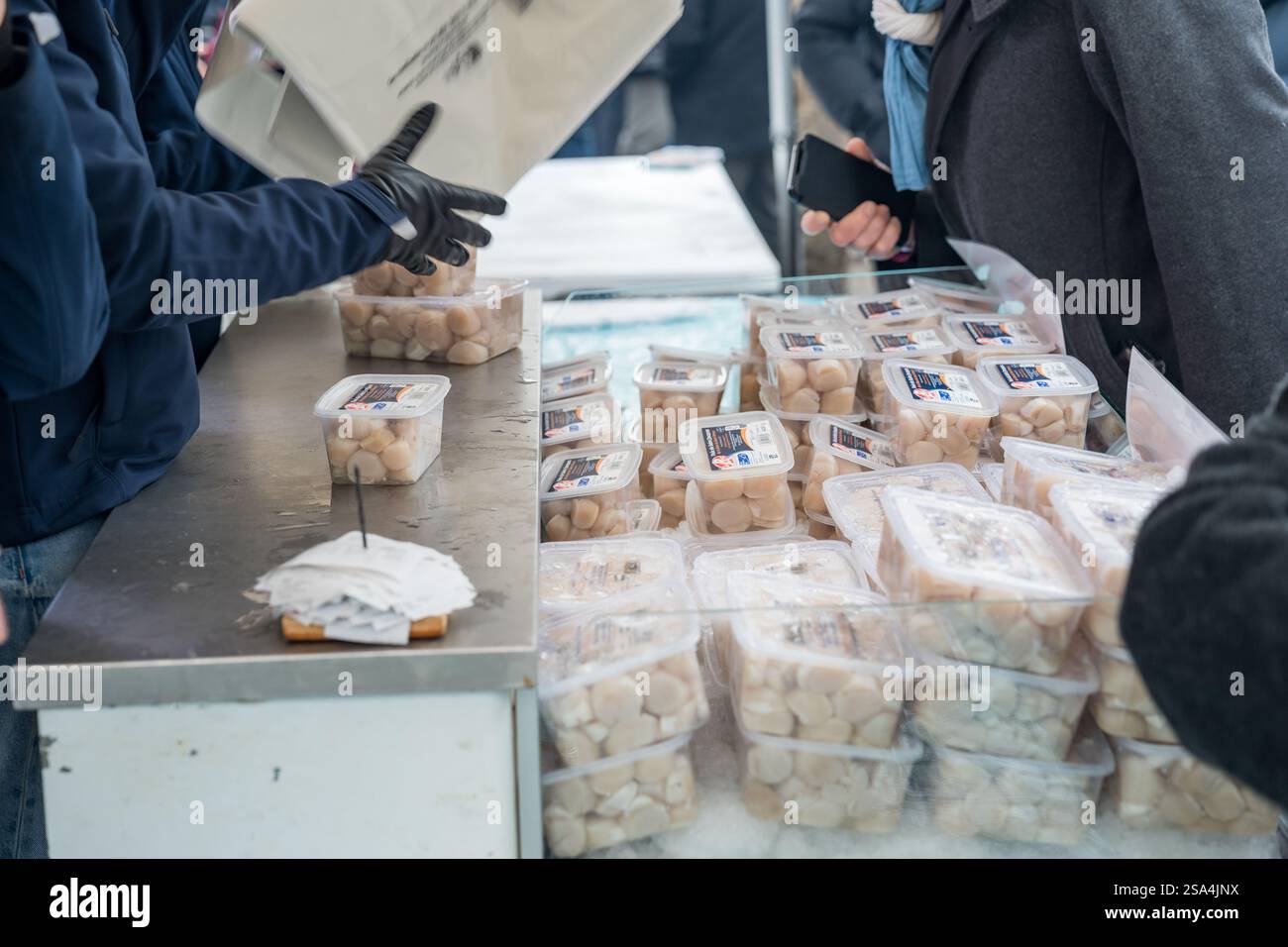 Busy market stall with eager customers buying fresh seafood Stock Photo ...