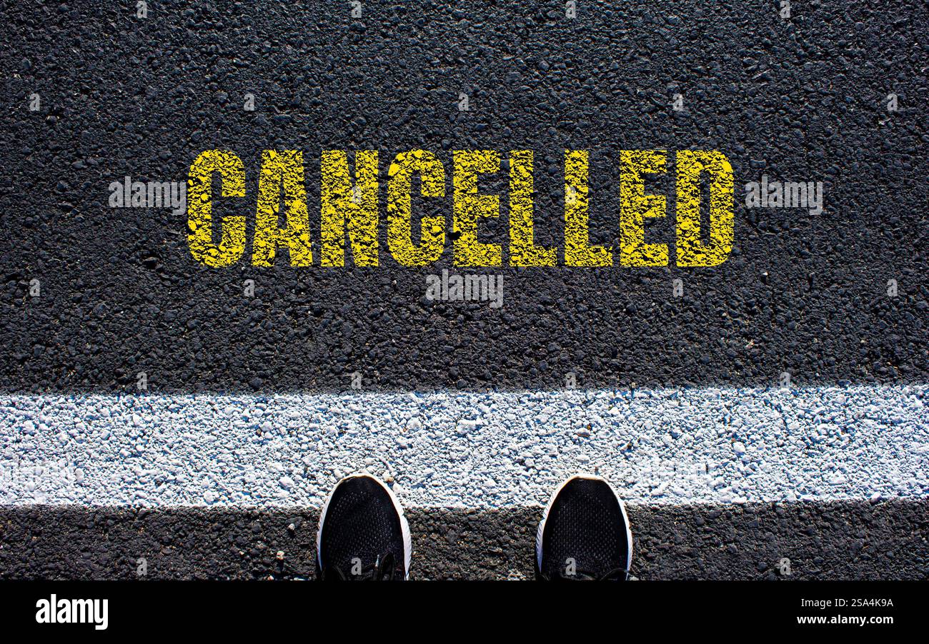 Cancelled message written on asphalt road. Conceptual cancelled symbol ...
