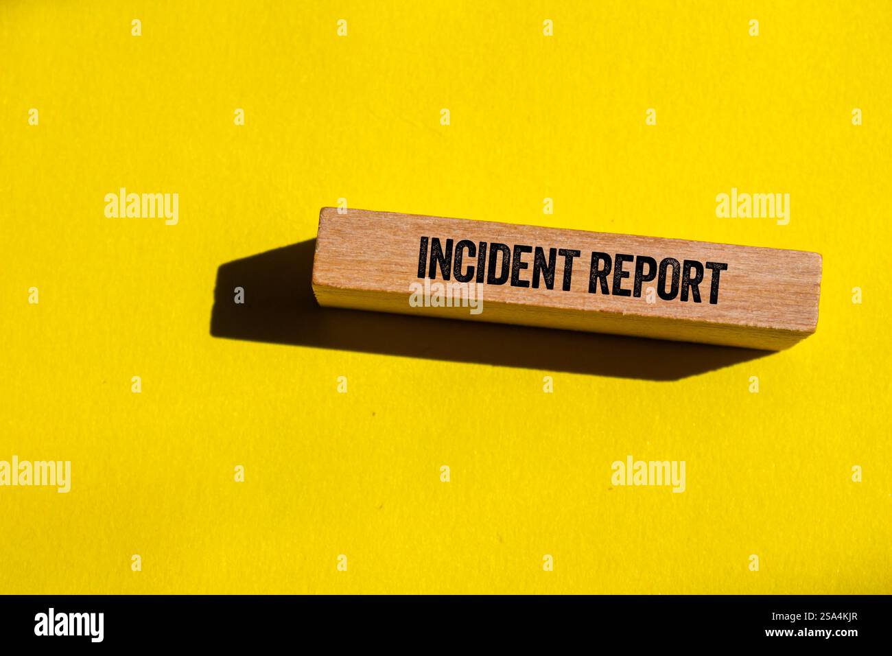 Incident report message written on wooden block on yellow background ...