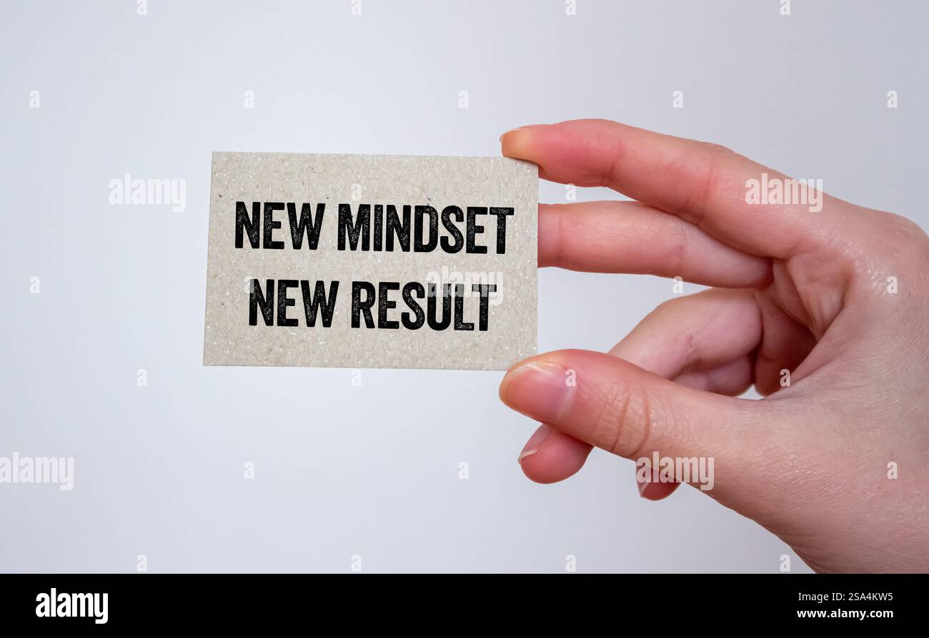 New mindset new result message written on a card in hand. Conceptual ...