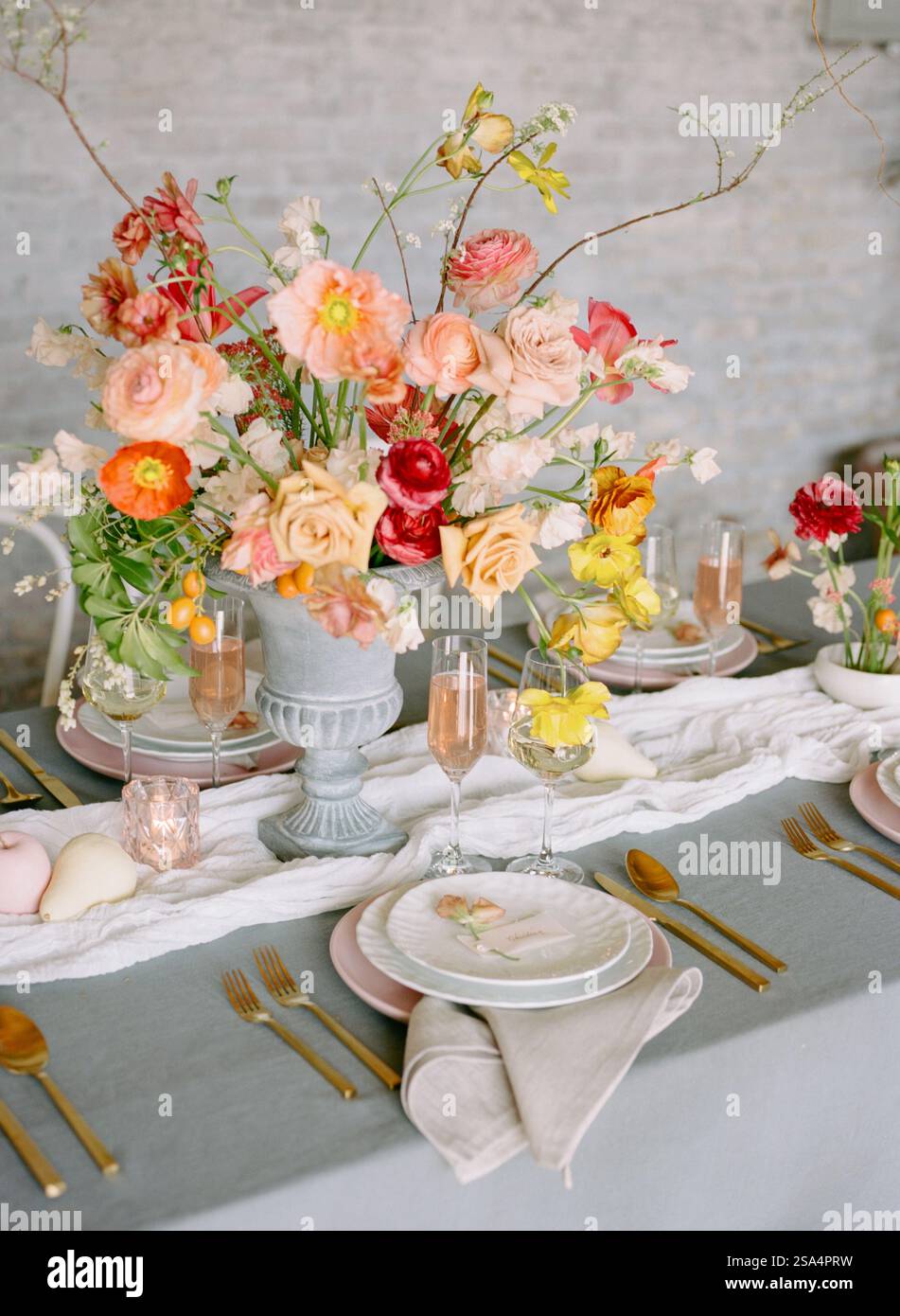 A beautifully arranged dining table features an exquisite floral ...
