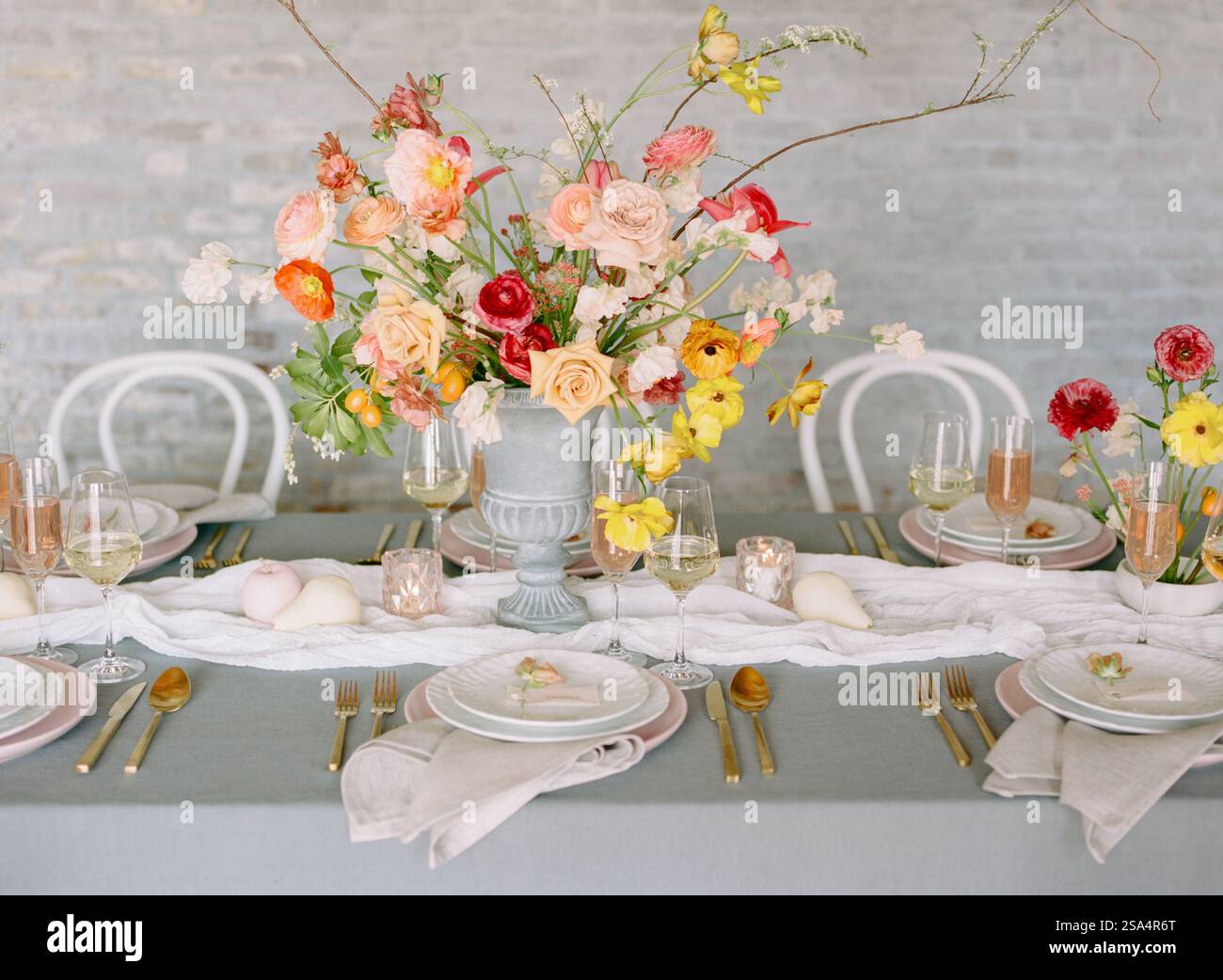 A beautifully arranged table features a stunning floral centerpiece ...