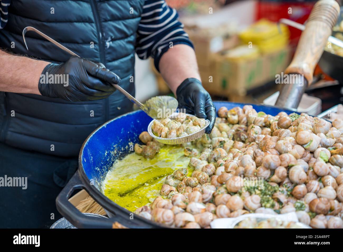 Culinary delight of escargot served fresh at a bustling market stall ...