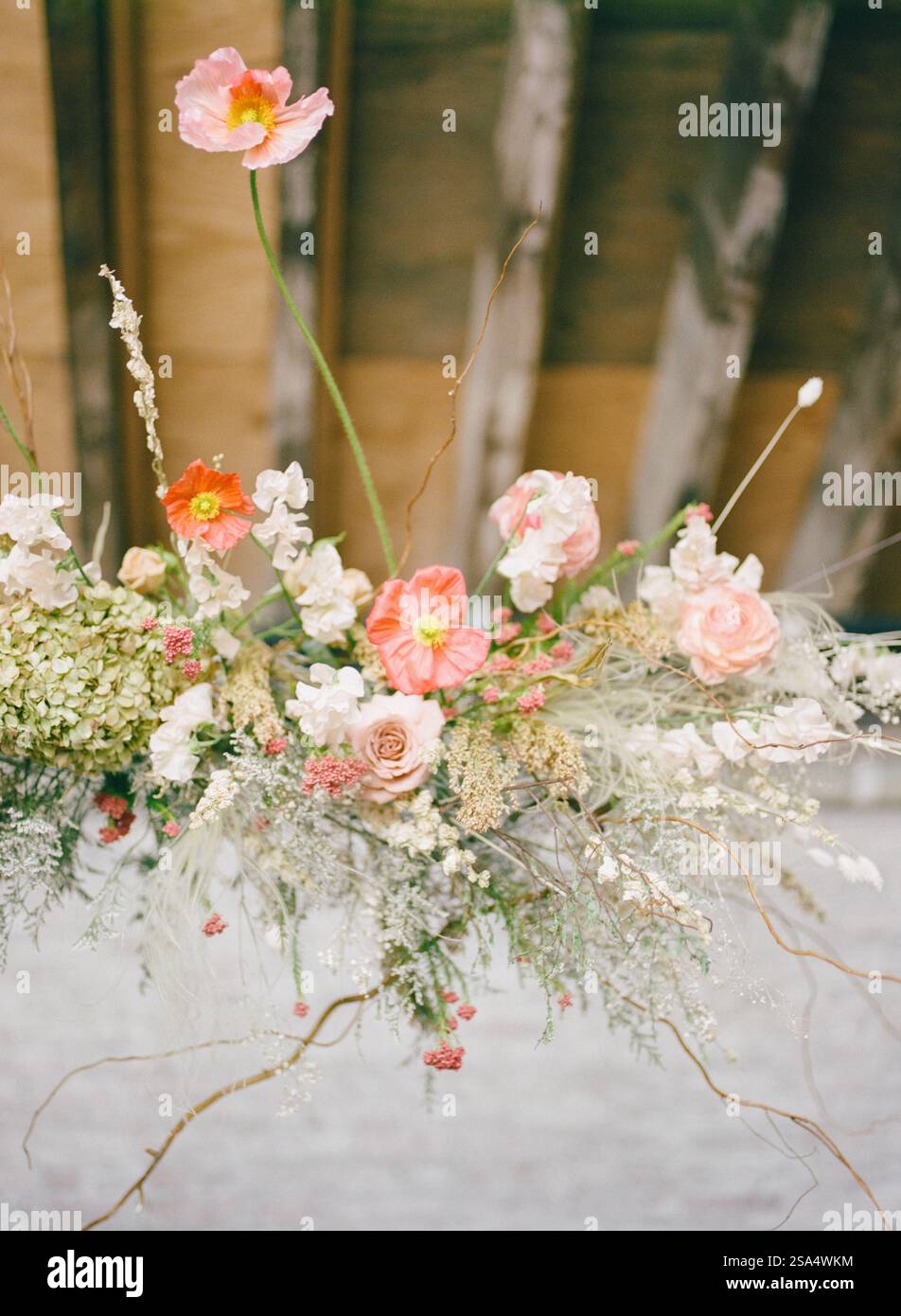 Delicate flowers in shades of pink and white are arranged elegantly ...