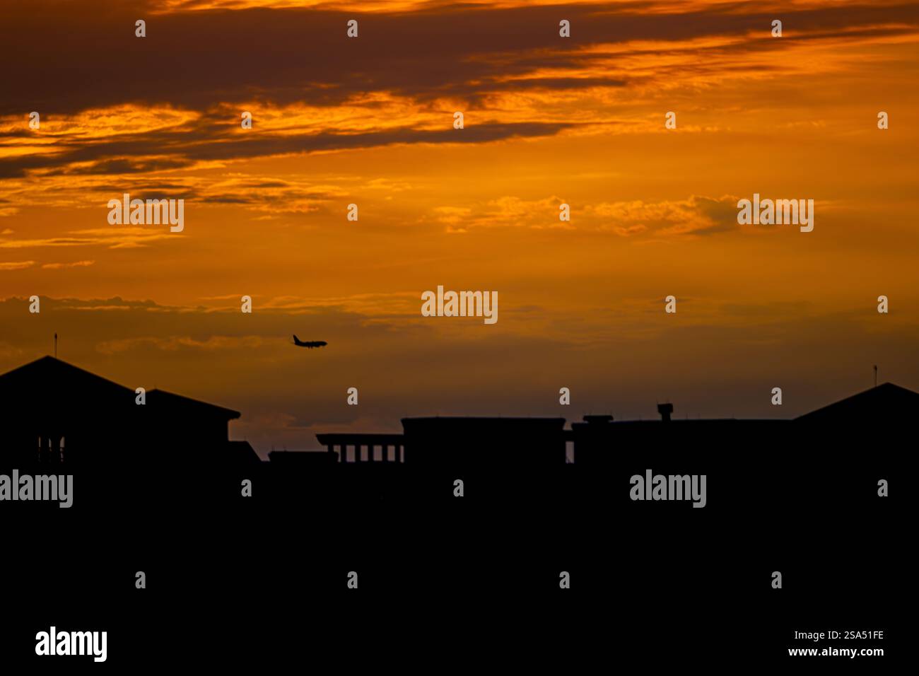 Tampa Bay sunset - Florida FL dusk with plane landing in orange ...