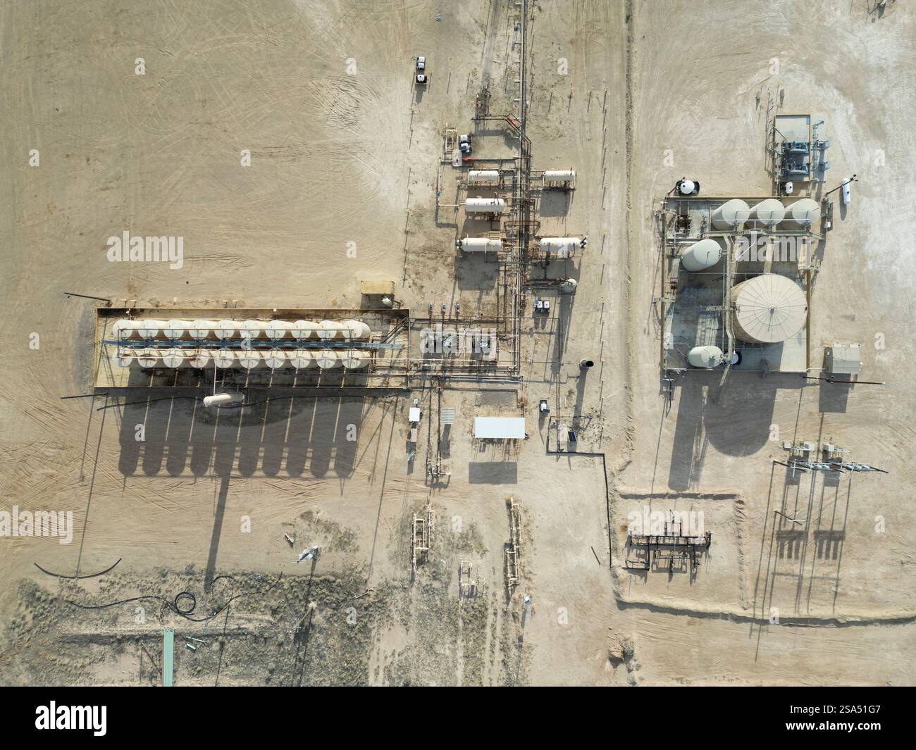 Aerial view looking down on part of a fracking operation with storage ...