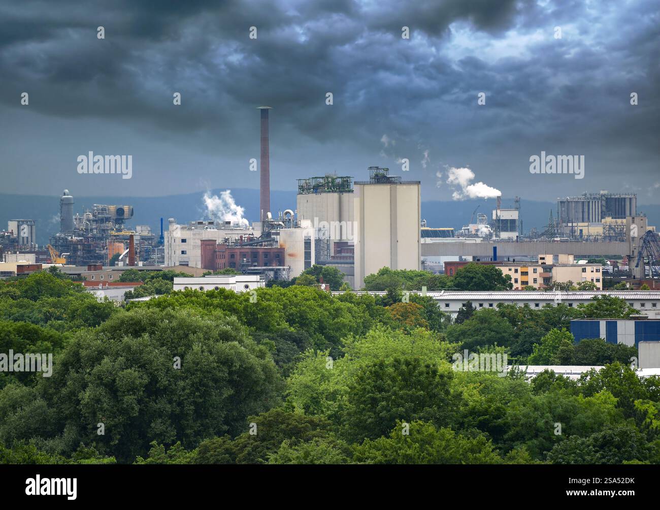 Aerial view of large factory with chimneys emitting smoke into the ...