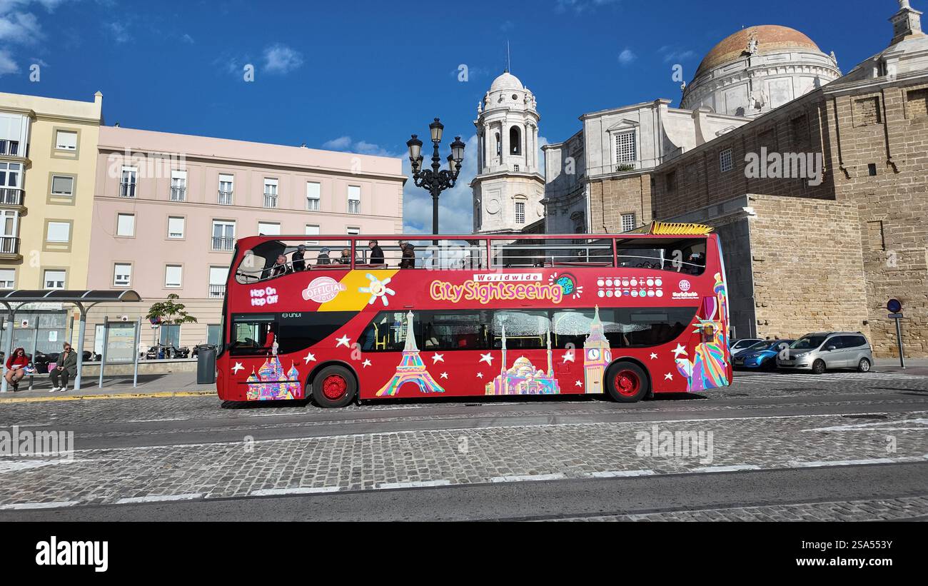 sight seeing tour bus passing by the Cádiz Cathedral, or Catedral de ...