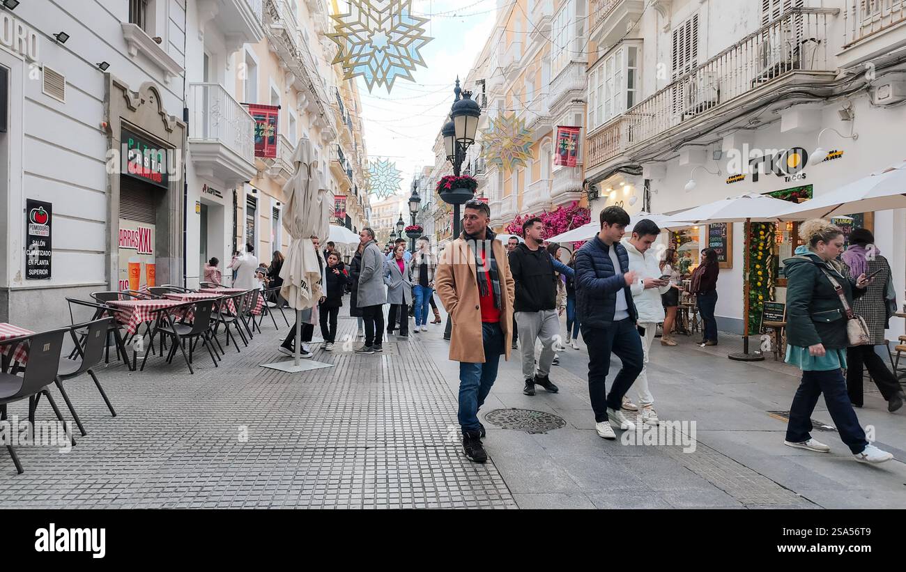 People on the street near Plaza de San Juan de Dios, a historic public ...