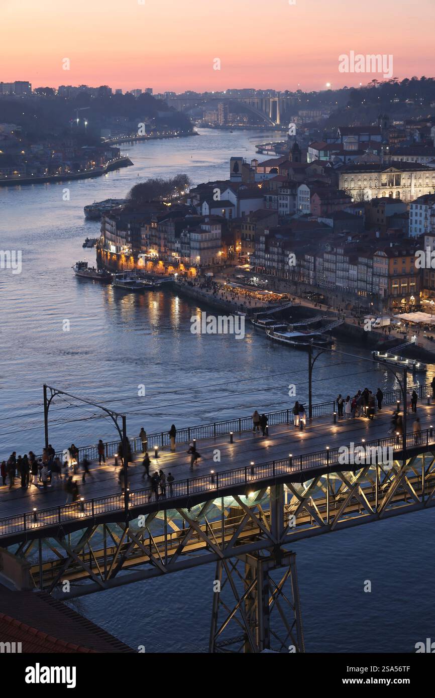 The twilight view of Dom Luís I Bridge over Douro River with historic ...