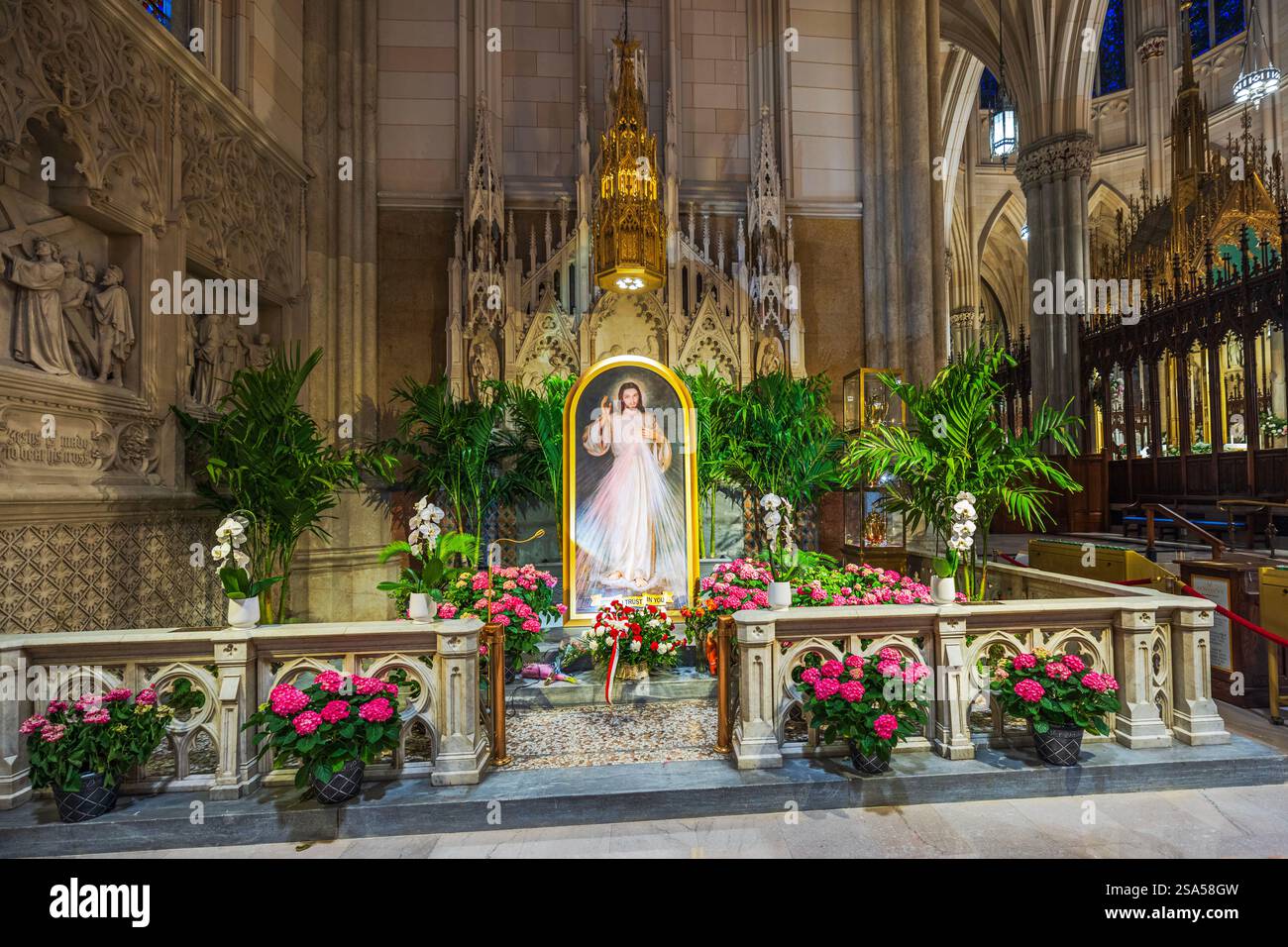 Jesus Christ altar with flowers and green plants inside gothic Catholic ...