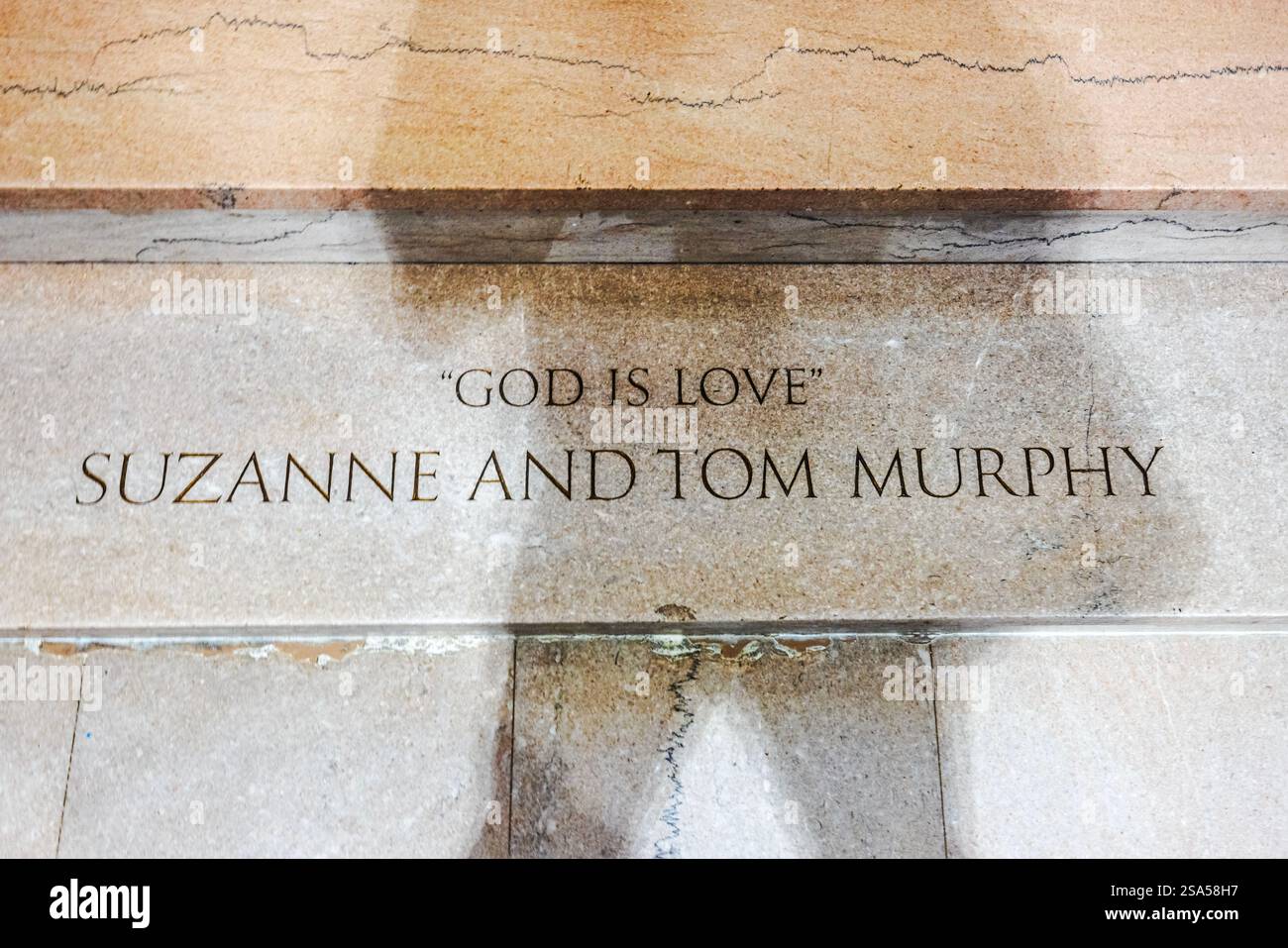 Stone inscription with phrase God is love and names Suzanne and Tom ...