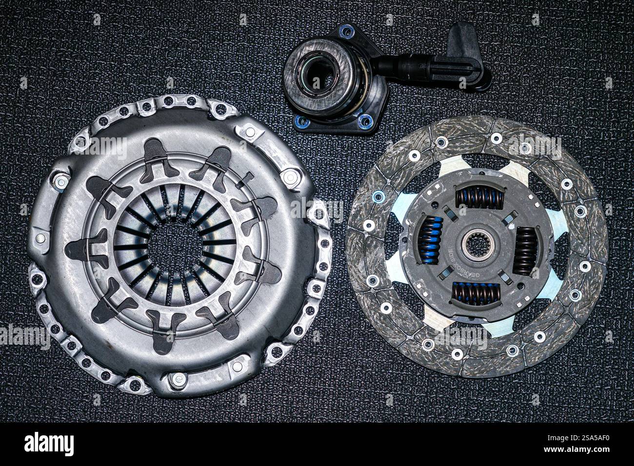 A new set of automotive clutch on a gray background, disc and clutch ...