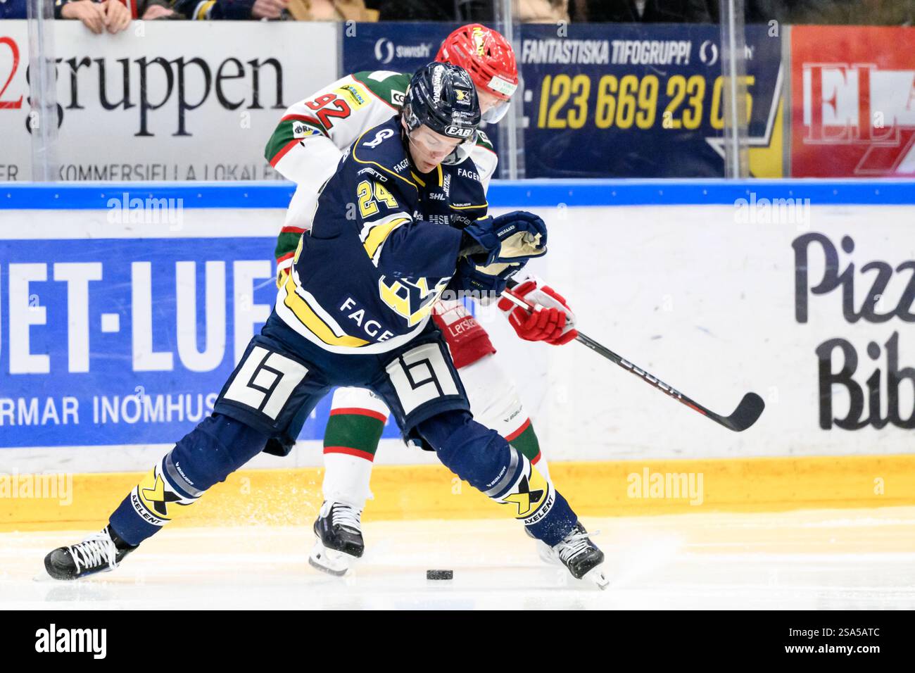 250128 HV71s Oscar Fisker Molgaard och Modos Jesper Olofsson under ishockeymatchen i SHL mellan ...