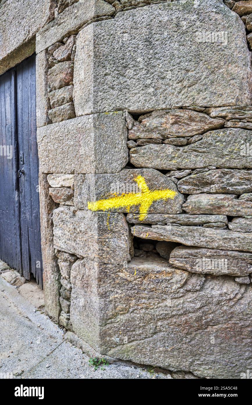 Spain, Galicia. Yellow arrow to guide pilgrims on their walk along the ...