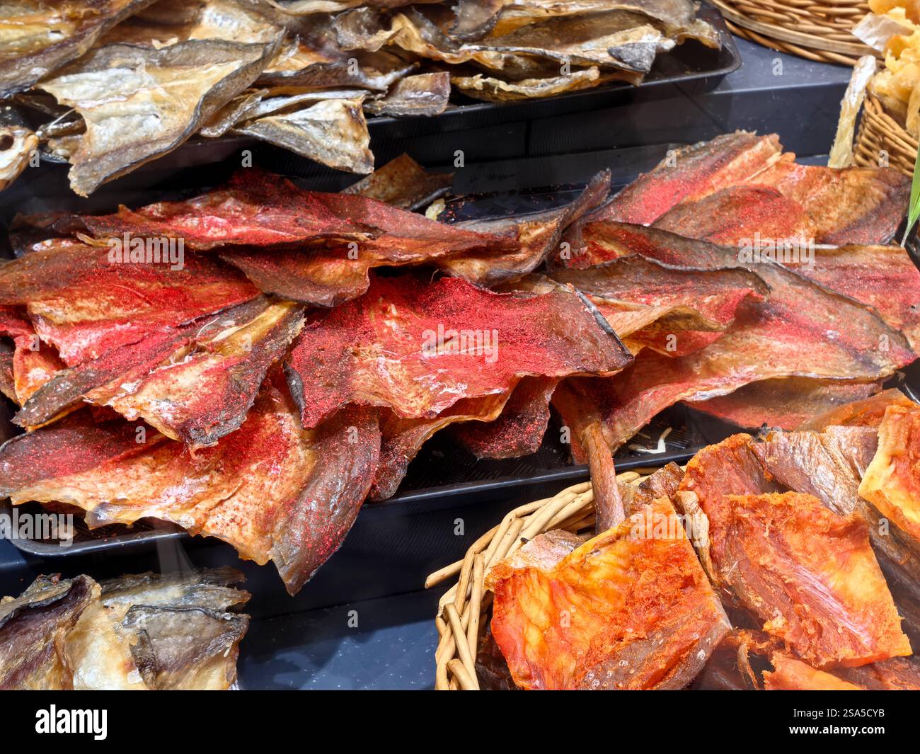 Colorful dried fish displayed at a bustling market, highlighting ...
