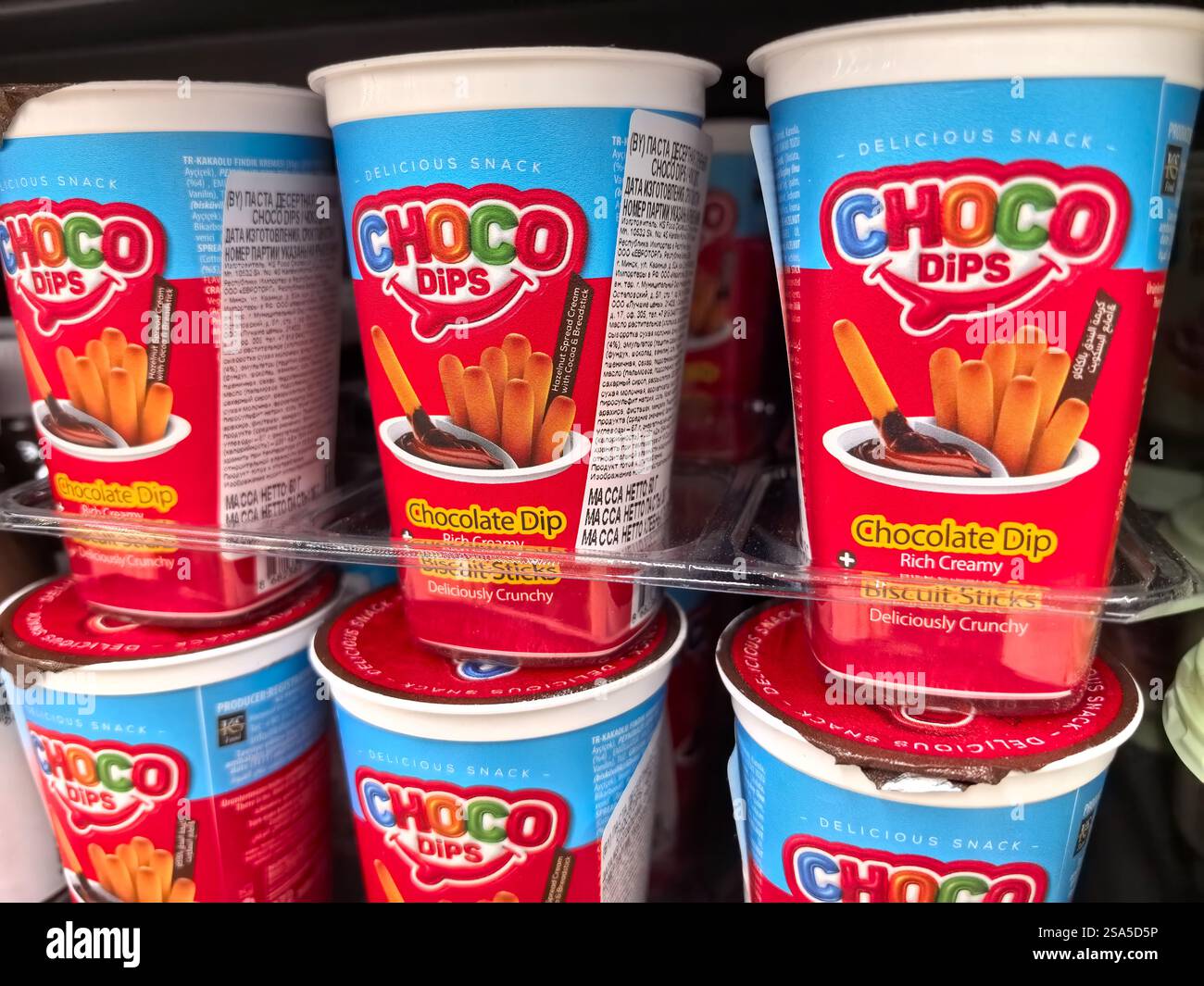 Bobruisk, Belarus - 26 January 2025: Colorful containers filled with crispy sticks and rich ...