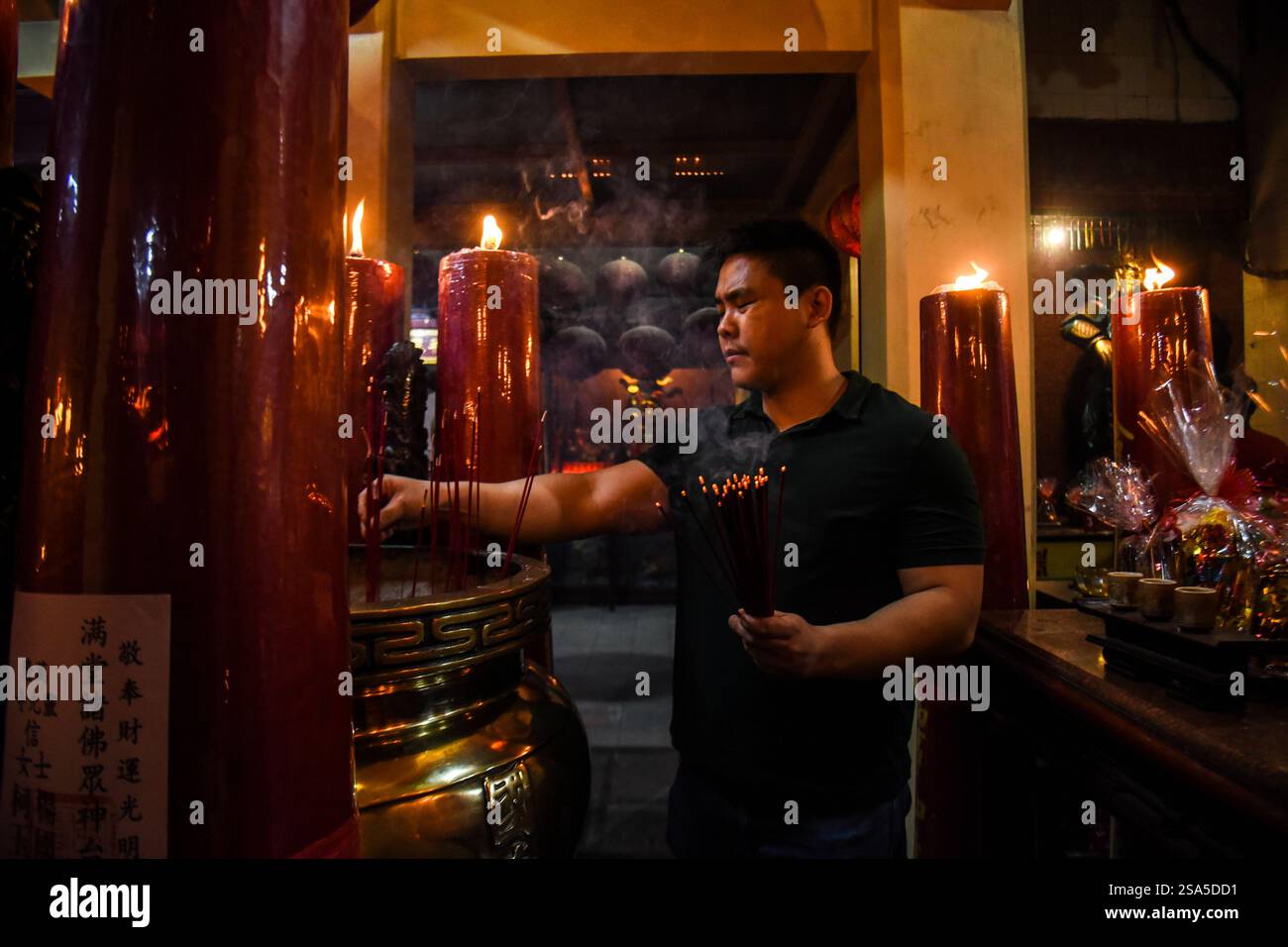 January 28, 2025, Bandung, West Java, Indonesia: A man holds incense ...