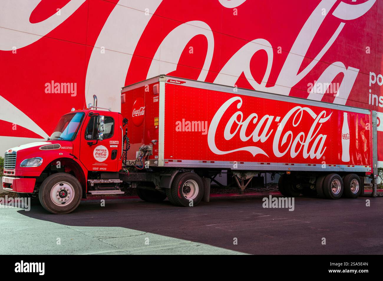 Coca-Cola red truck parked in a street in front of a building with Coca ...