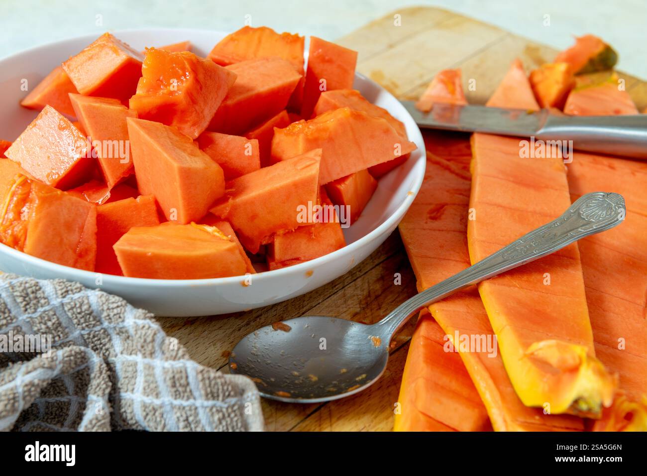 Yellow orange colour sweet soft papaya flesh on a plate ready to be ...