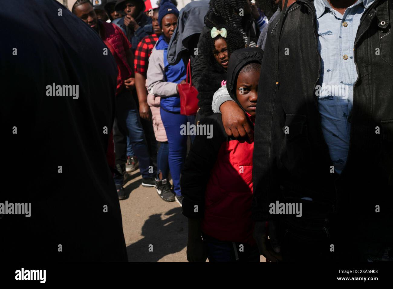 Migrants from Haiti stand in line outside the Mexican Commission for ...