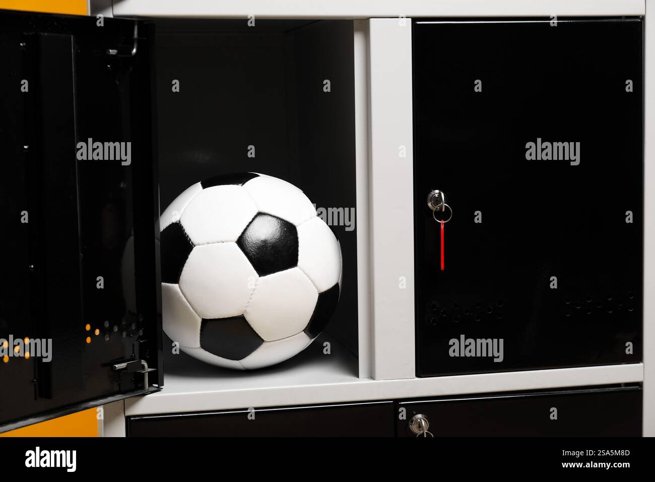 Open locker with soccer ball on orange background, closeup Stock Photo ...