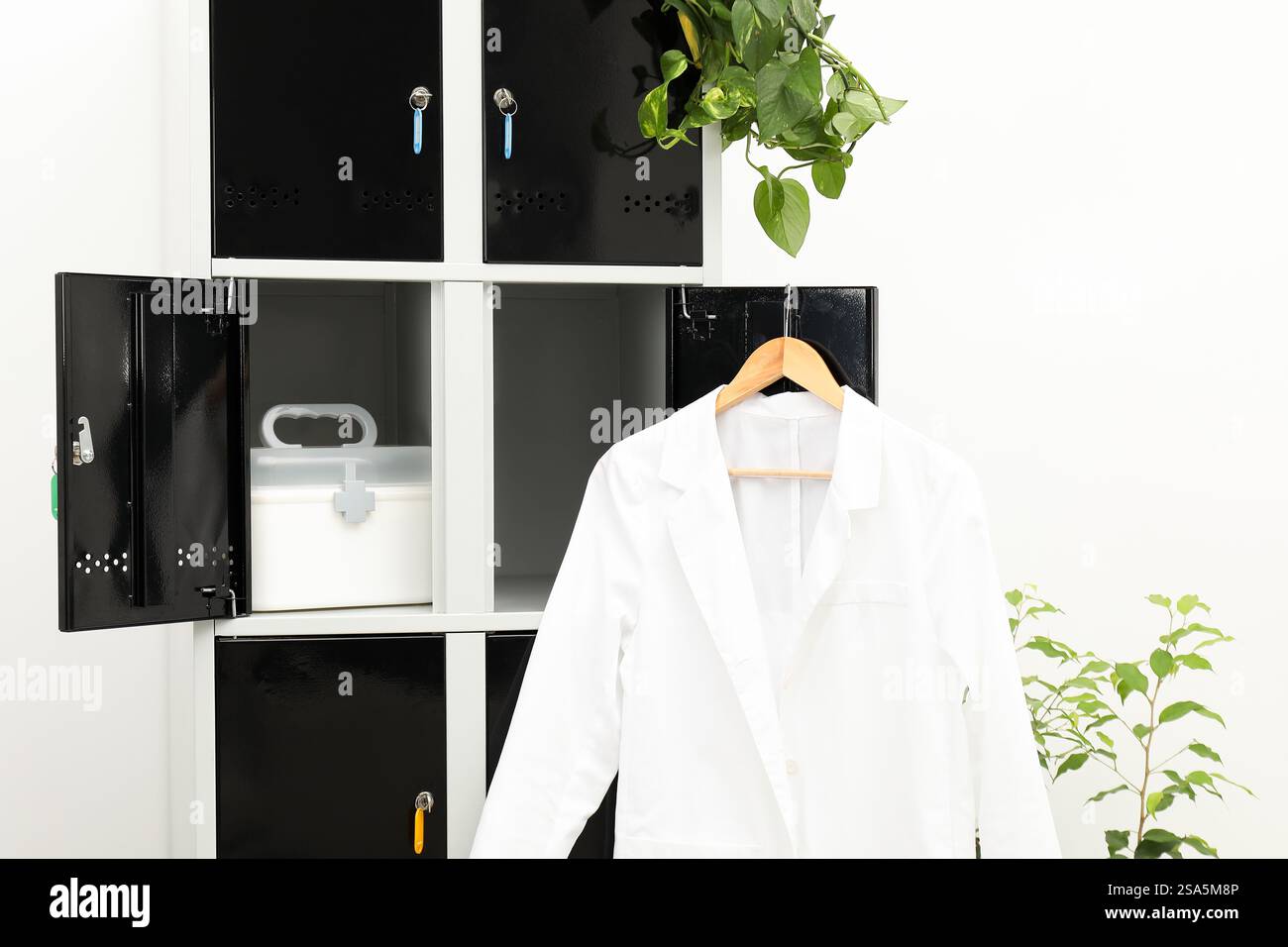 Medical personnel uniform on locker in changing room Stock Photo - Alamy