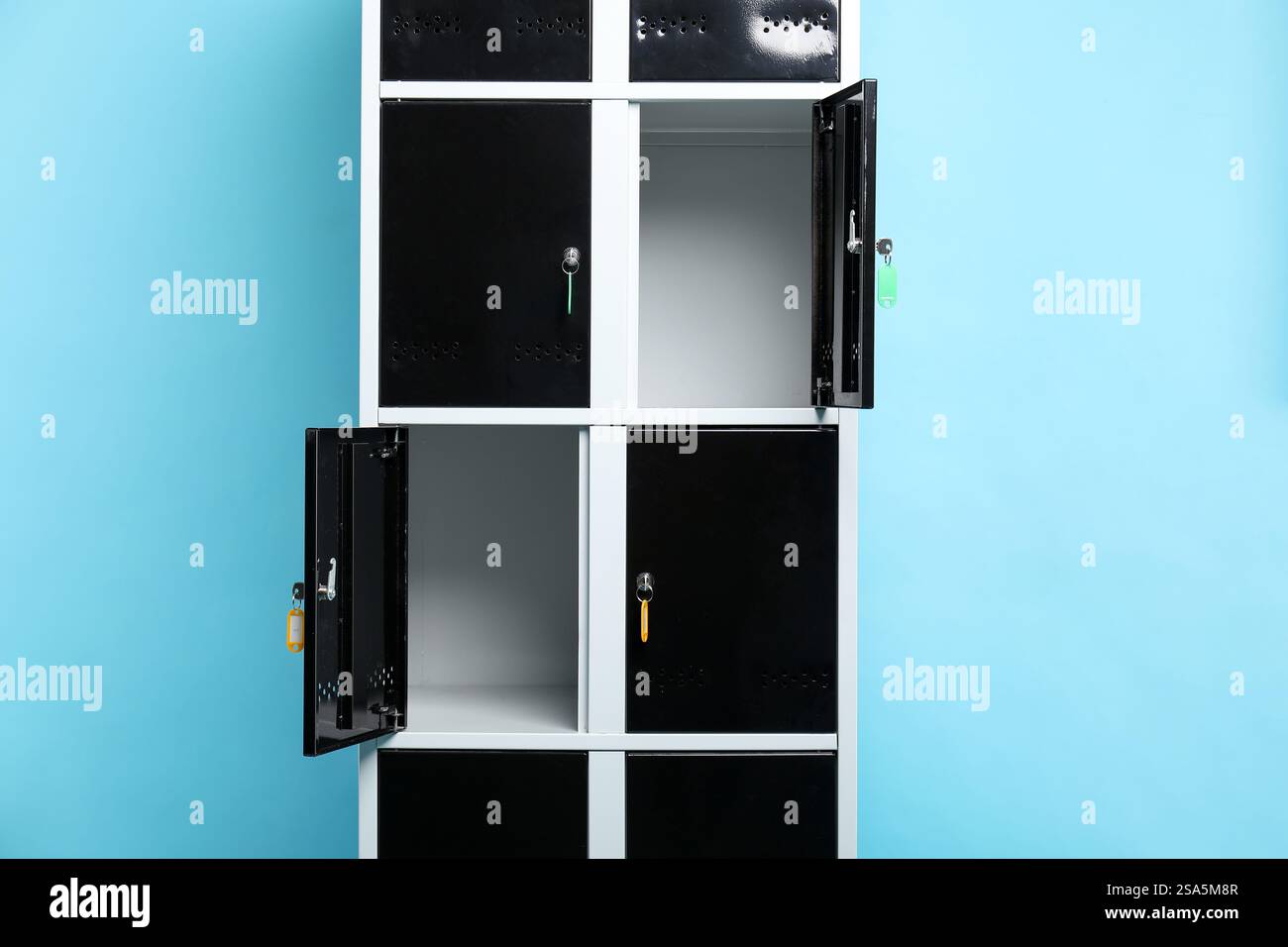 Modern lockers with keys on light blue background Stock Photo - Alamy