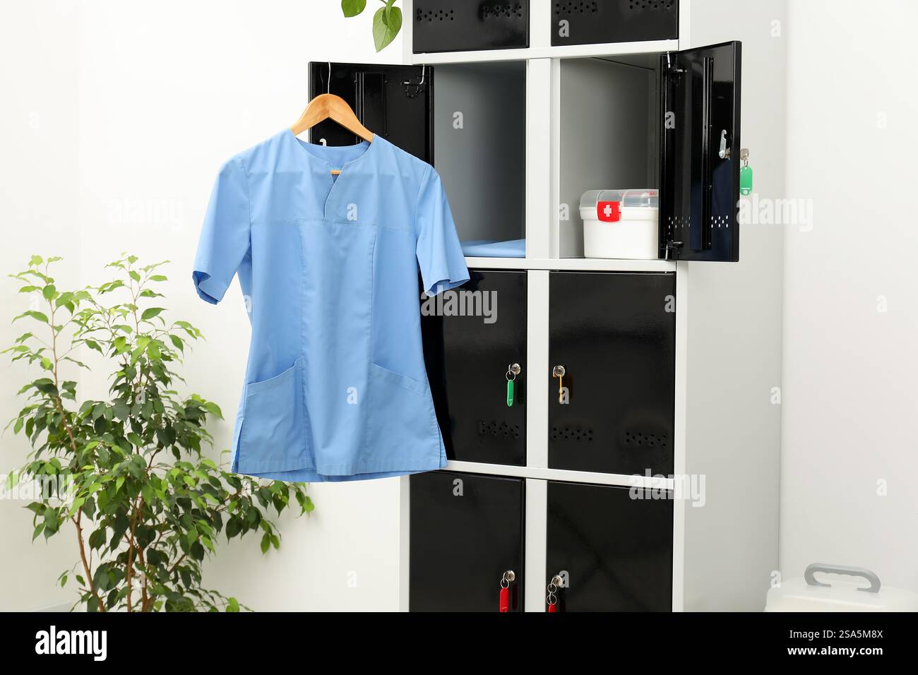 Medical personnel uniform on locker in changing room Stock Photo - Alamy