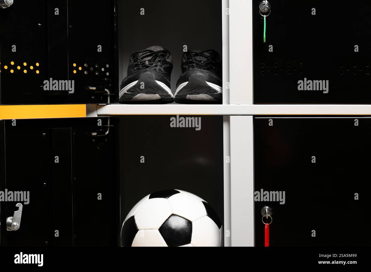Open lockers with sneakers and soccer ball, closeup Stock Photo - Alamy