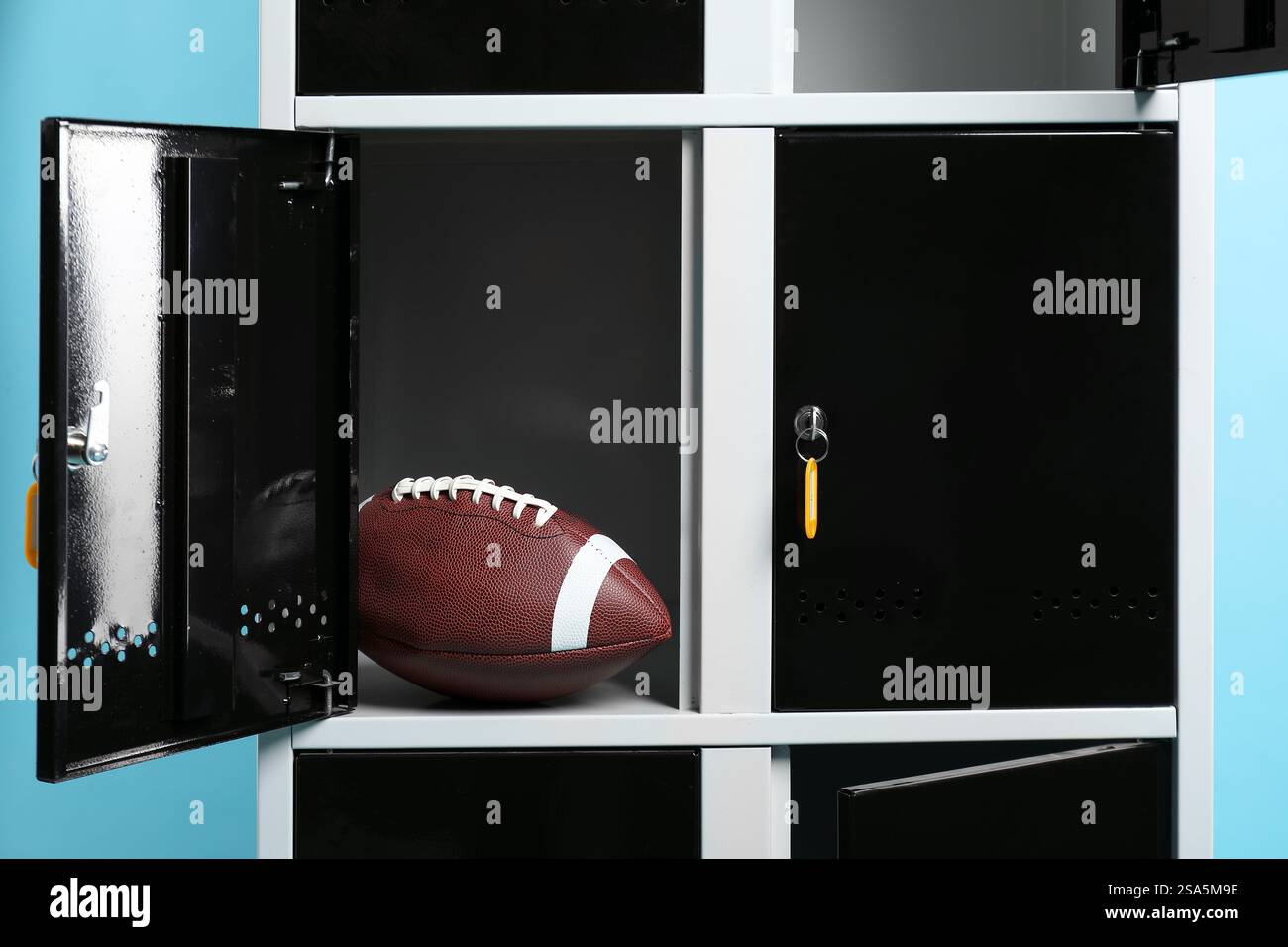 Open locker with american football ball on light blue background Stock ...