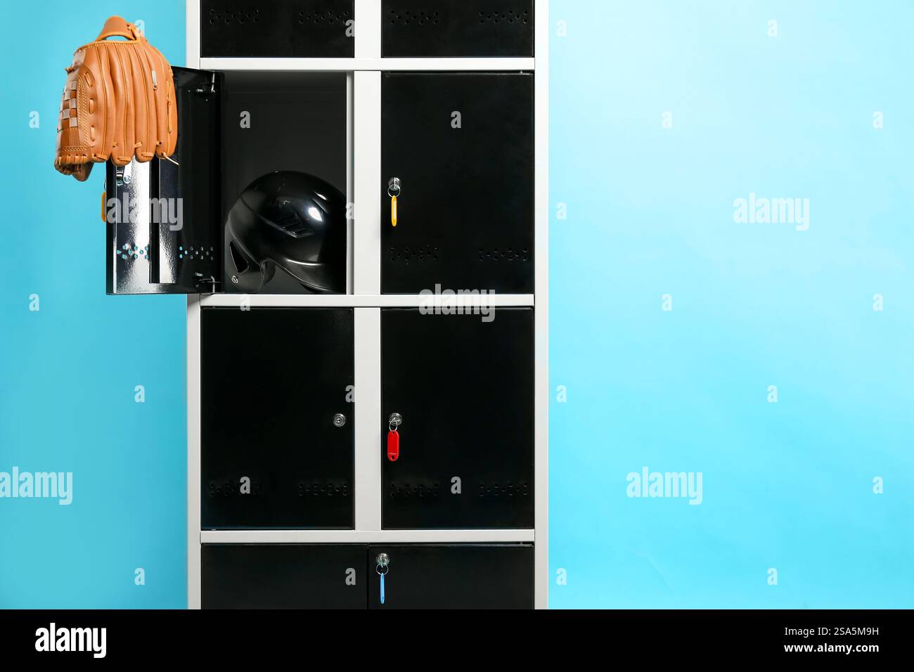 Open locker with baseball glove and helmet on light blue background ...