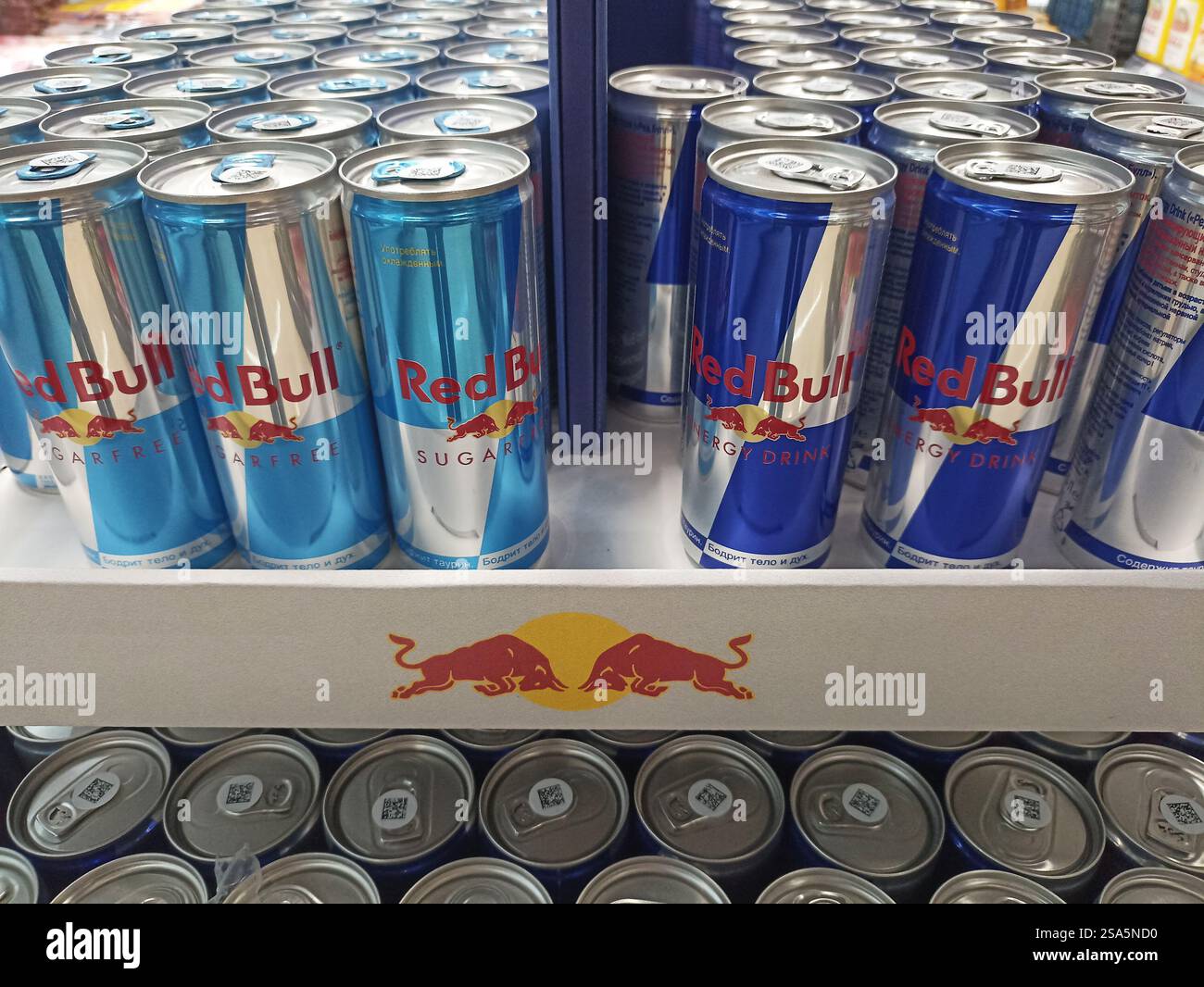 Variety of red bull energy drink cans on display at store Stock Photo ...